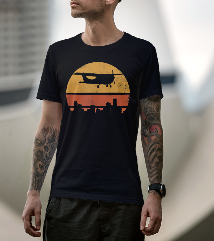 Retro Pilot C172 Flying Silhouette Over Sunset Cityscape T-Shirt