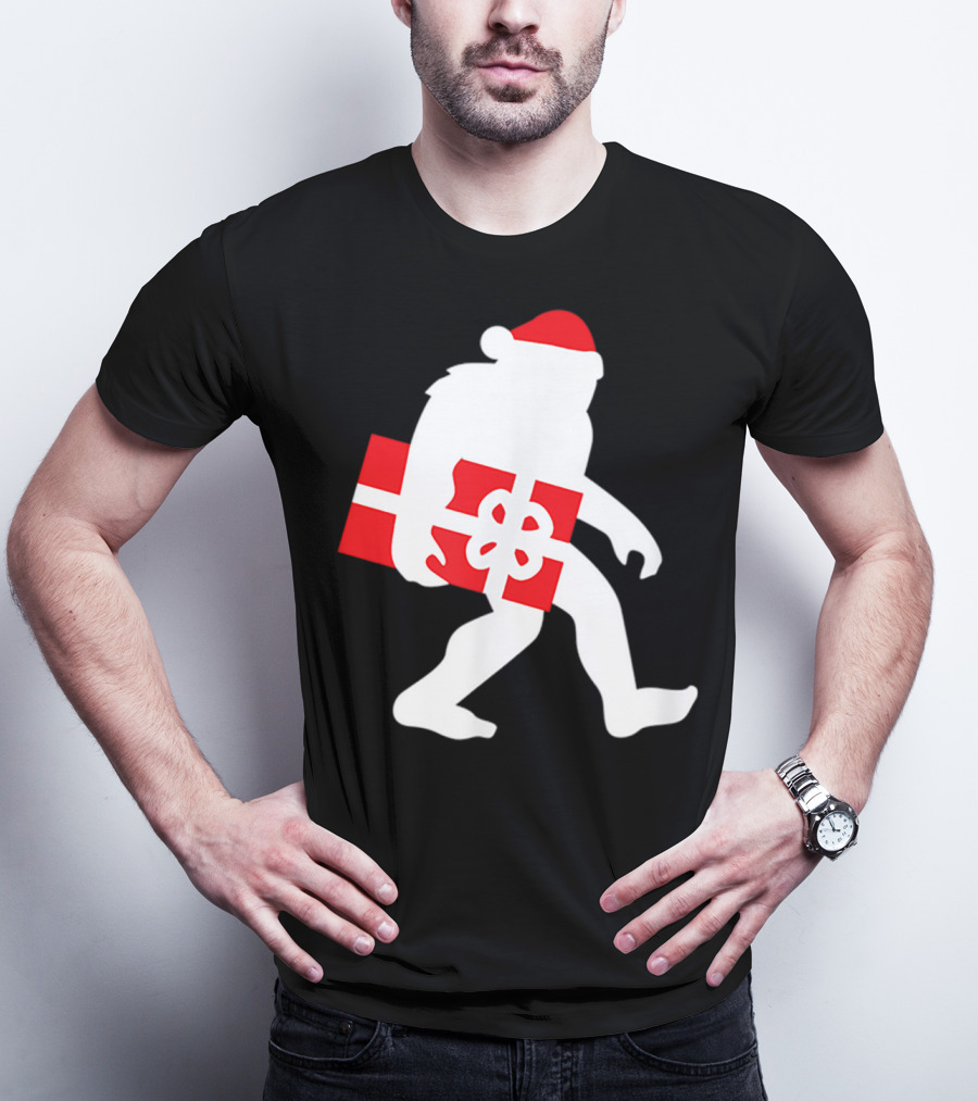 Nice Bigfoot Carrying Christmas Gift In Santa Hat T-Shirt