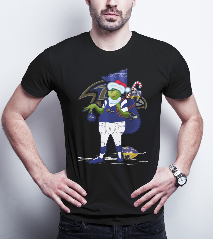Grinch Santa Holding Candy Cane Bag And Baltimore Ravens Football In Ravens T-Shirt