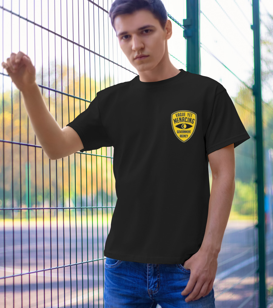 Vague Yet Menacing Government Agency Yellow Badge With Eye T-Shirt