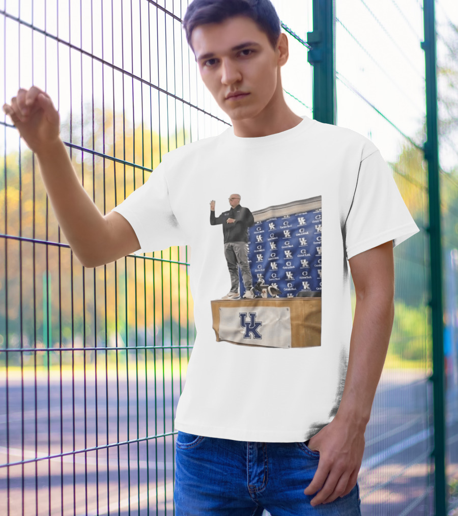 UK Volleyball Coach Craig Skinner Standing On Table With UK Logo And Awards T-Shirt