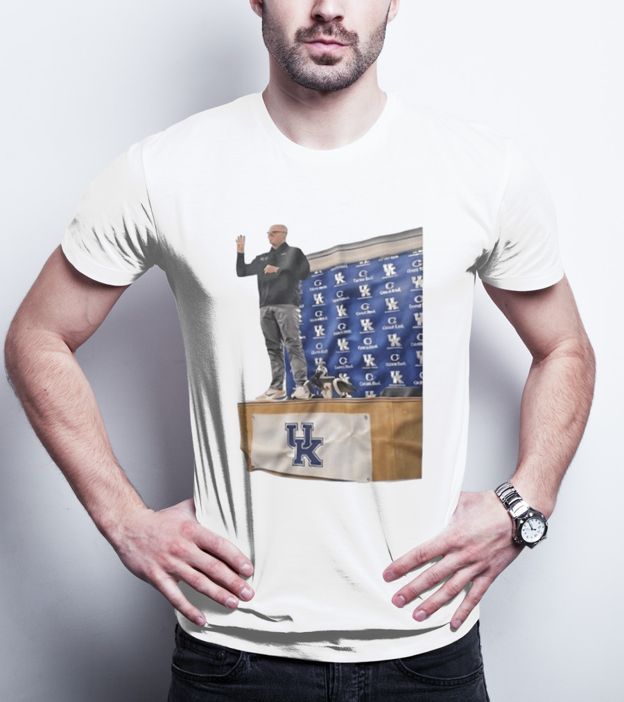 UK Volleyball Coach Craig Skinner Standing On Table With UK Logo And Awards T-Shirt