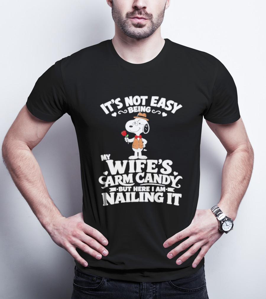 Snoopy It's Not Easy Being My Wife's Arm Candy But Here I Am Nailing It T-Shirt