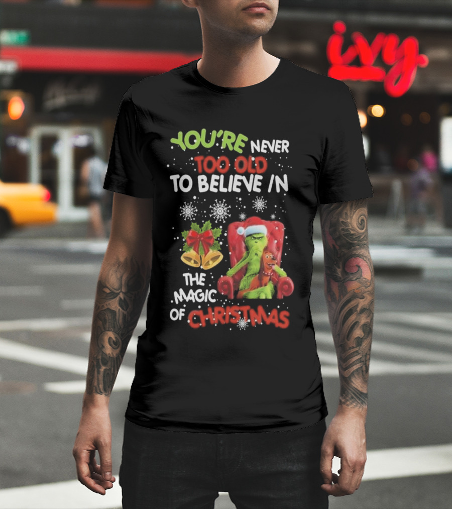 YOU'RE NEVER TOO OLD TO BELIEVE IN THE MAGIC OF CHRISTMAS GRINCH WITH MAX SITTING IN CHAIR SNOWFLAKES HOLIDAY BELLS AND BOW T-Shirt