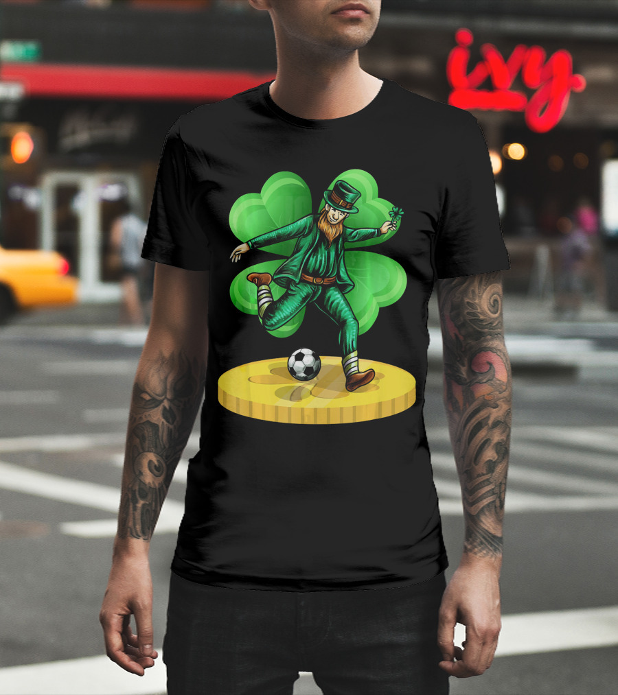 Leprechaun Kicking Soccer Ball On Gold Coin With Shamrock Background T-Shirt