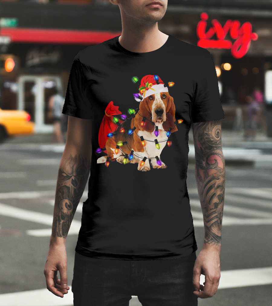Basset Hound Wrapped In Christmas Lights With Santa Hat And Red Sack T-Shirt