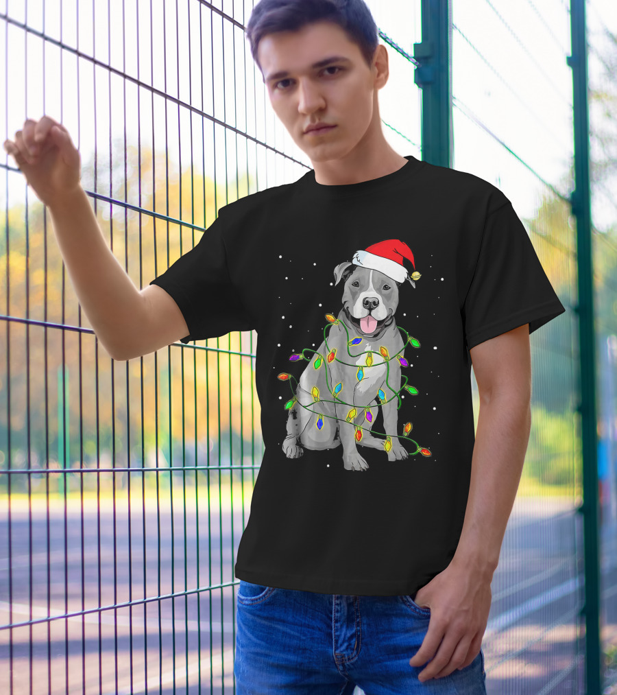 Pitbull In Santa Hat Wrapped In Christmas Lights With Snowy Background T-Shirt